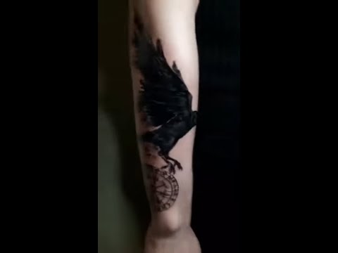 Black raven watercolor Tattoo on a man's arm