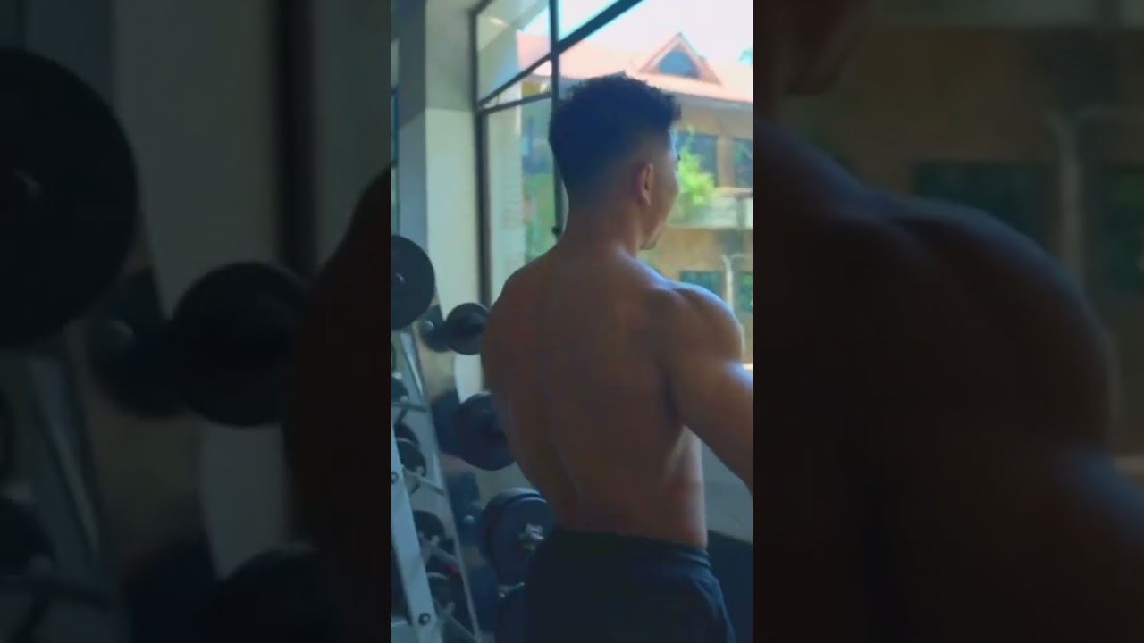 muscular chinese man showing off his muscles 💪