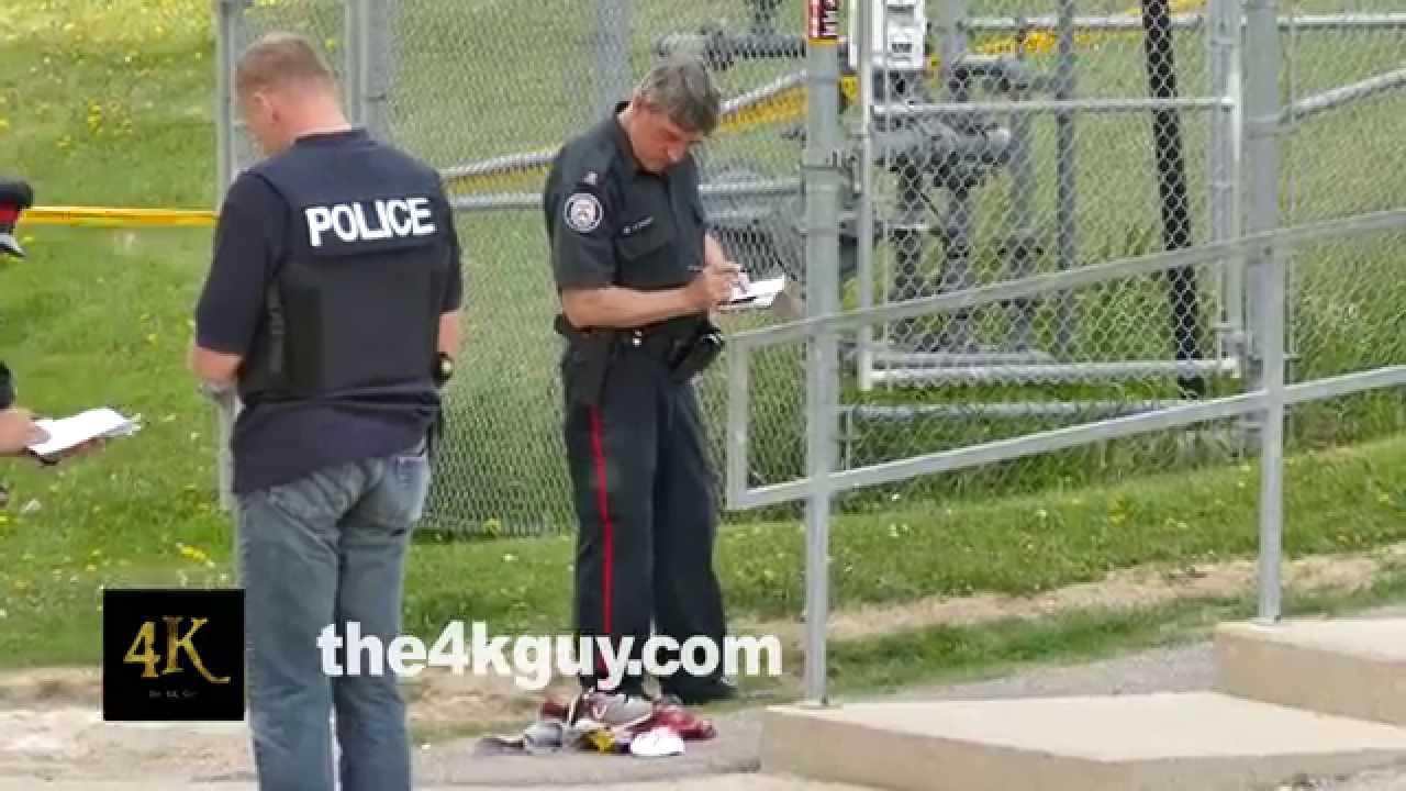 4K UHD - Investigators and cops discussing at outdoor crime scene