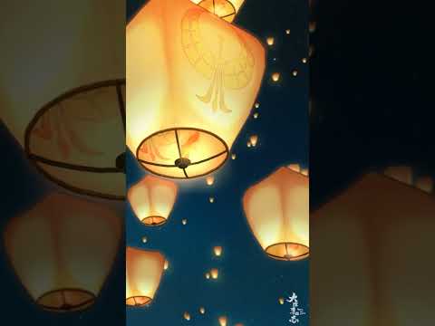 Floating Chinese lanterns at nighttime