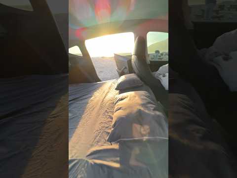 Car camping in the Tesla Model Y by the beach