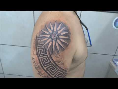 Hellenic tattoo by Chris Cosmos with meandros, delfiko epsilon, eleftheria inscription, vergina sun