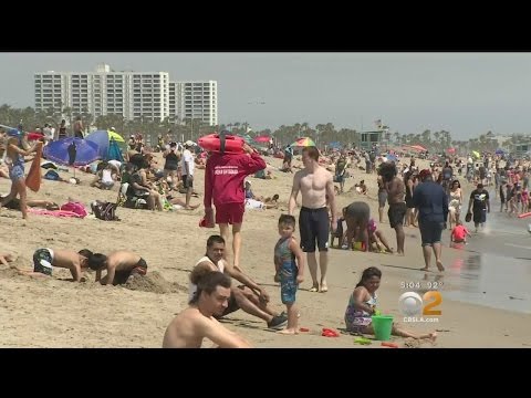 Thousands Hit The Beach To Escape Triple-Digit Temperatures