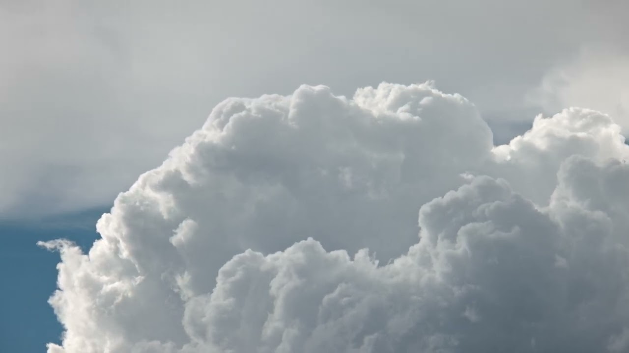 Cumulus clouds moving through the sky with zoomed view FREE STOCK VIDEO