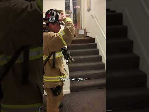 Fireman signs with a young boy.