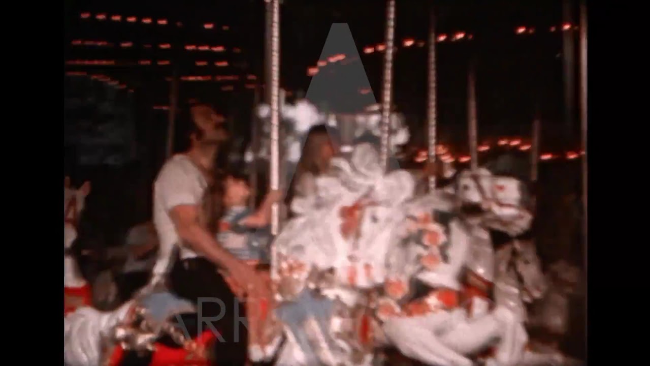 Vintage footage of amusement ride  - carousel horses