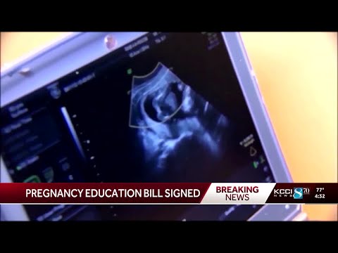 Iowa Gov. Kim Reynolds signs two dozen bills into law