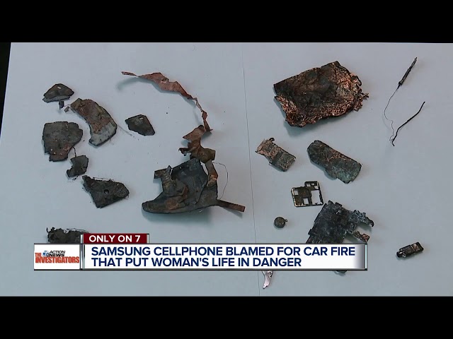 Woman with two Samsung handsets in cart watches as spark becomes fire ...