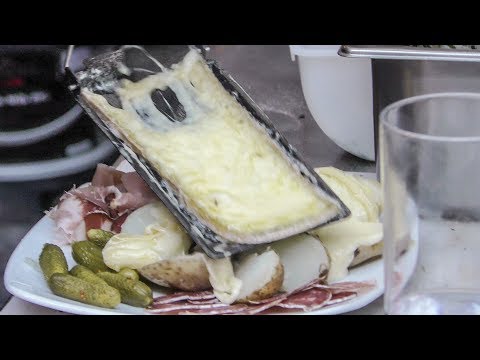 French Raclette. Warm Melted Cheese on Ham and More Cooking at a "Cheese Restaurant"