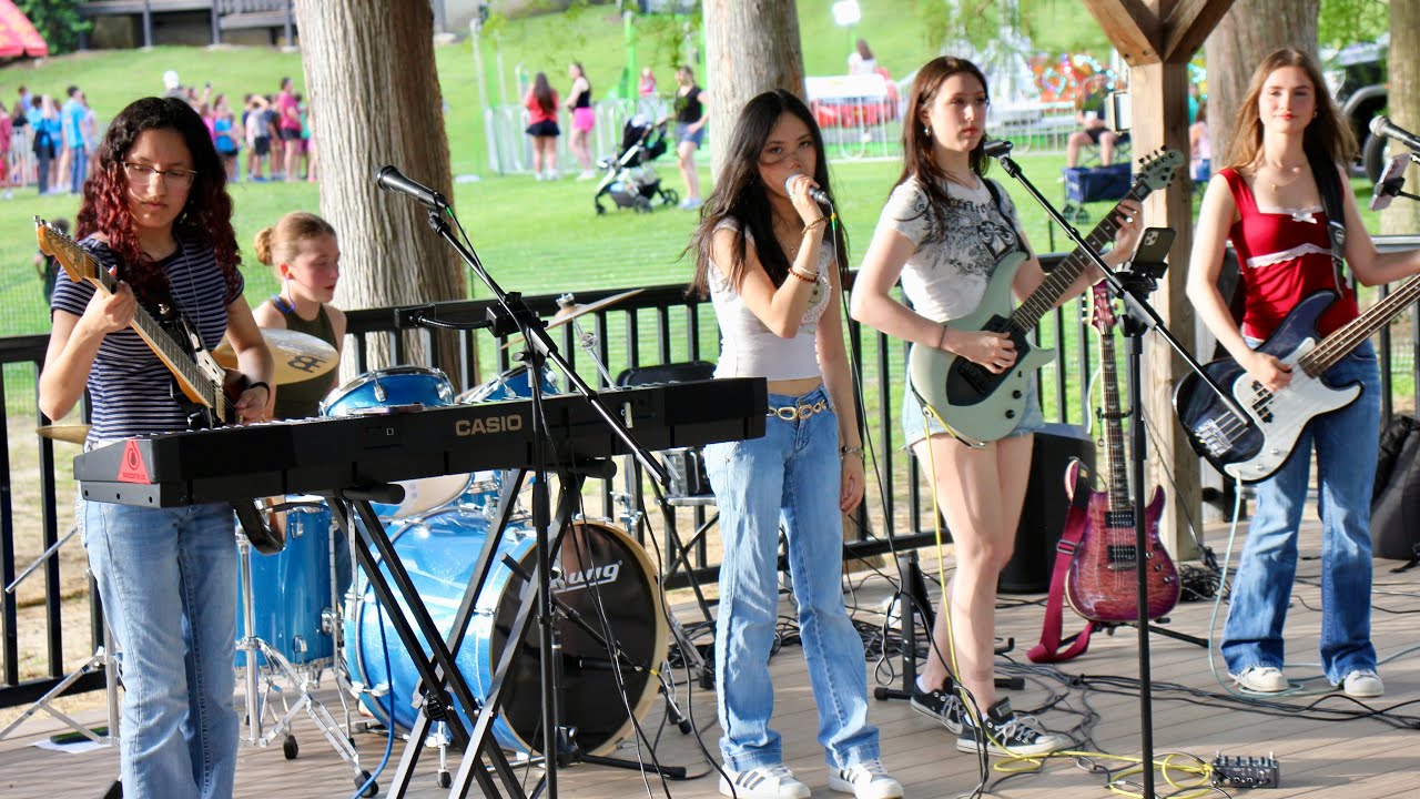 All teen (14-17) all girl rock band performs “Whole Lotta Love” by Led Zeppelin at school.