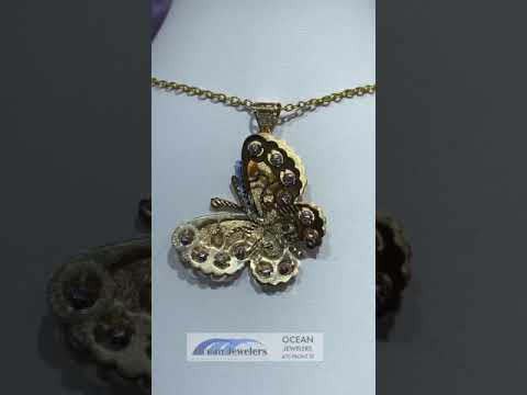 St. Maarten - Caribbean Jewelry store "Ocean Jewelers" Big look fancy gold pendants.