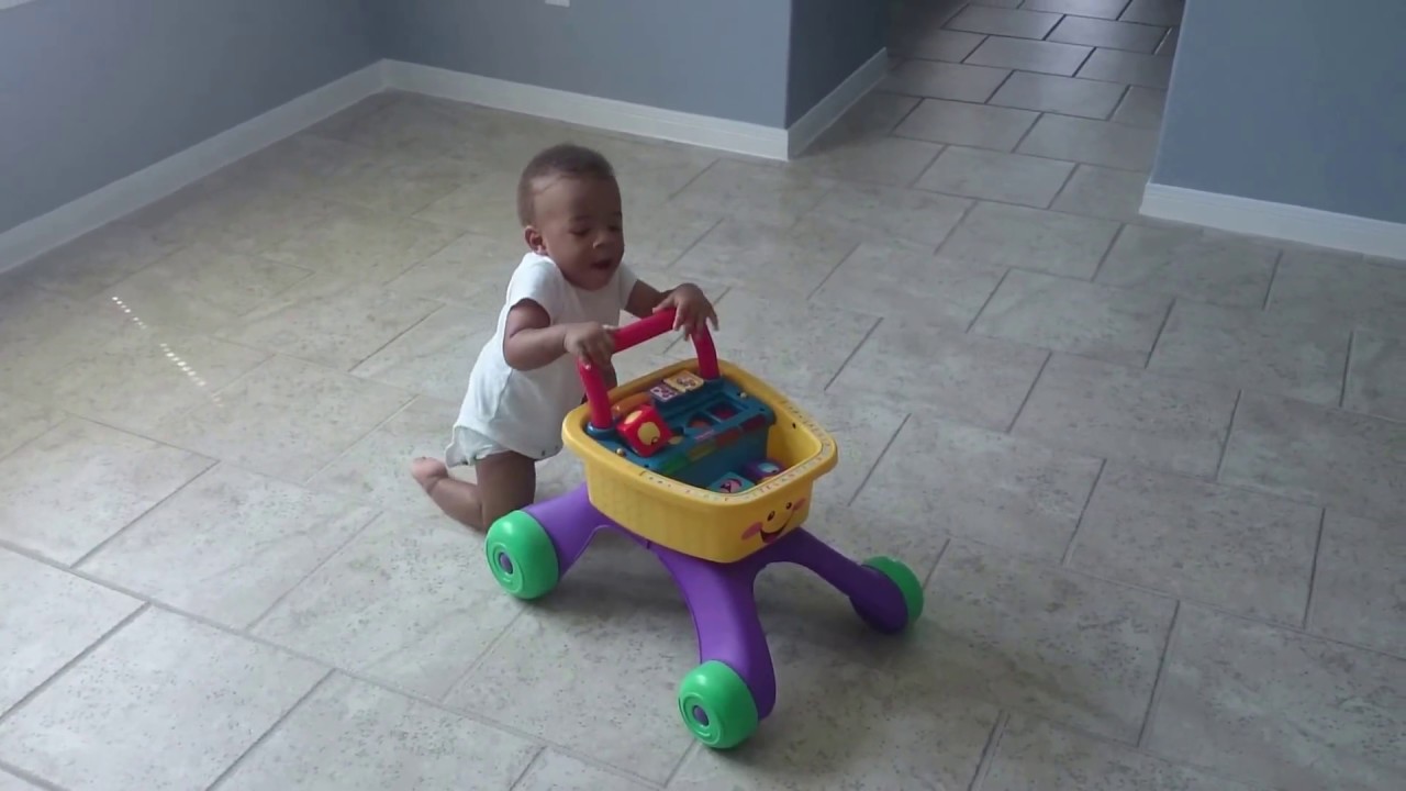 Luke playing with the shopping cart