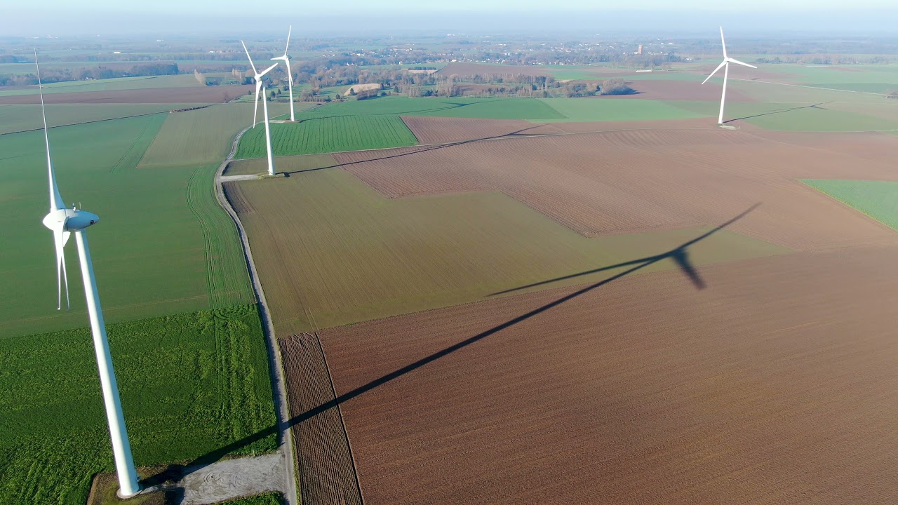 Aerial view of windmills and agricultural fields in 4K  | Free Stock Video