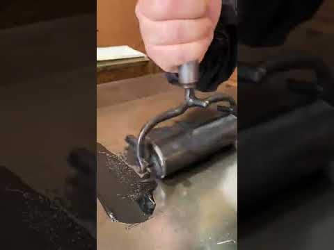Rolling out rubber base ink on the ink stone in preparation for letterpress printing.