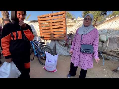Palestinians receive flour at displacement camp in Khan Younis | REUTERS