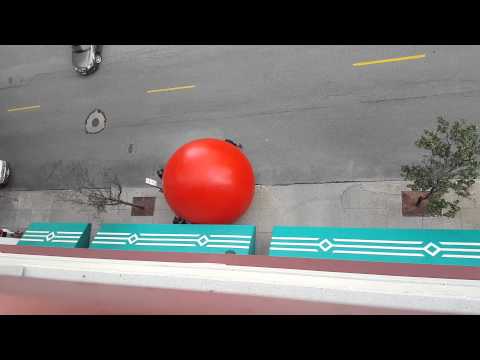 Hilarious moment security chase giant red ball down road after it ...
