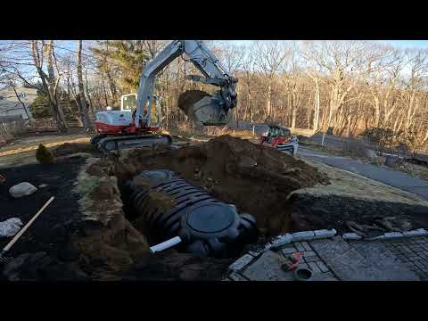 Takeuchi TB290 backfilling a Roth 1260 gallon septic tank.