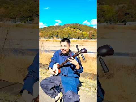It’s a traditional Japanese instrument called “shamisen.” It has only three strings.