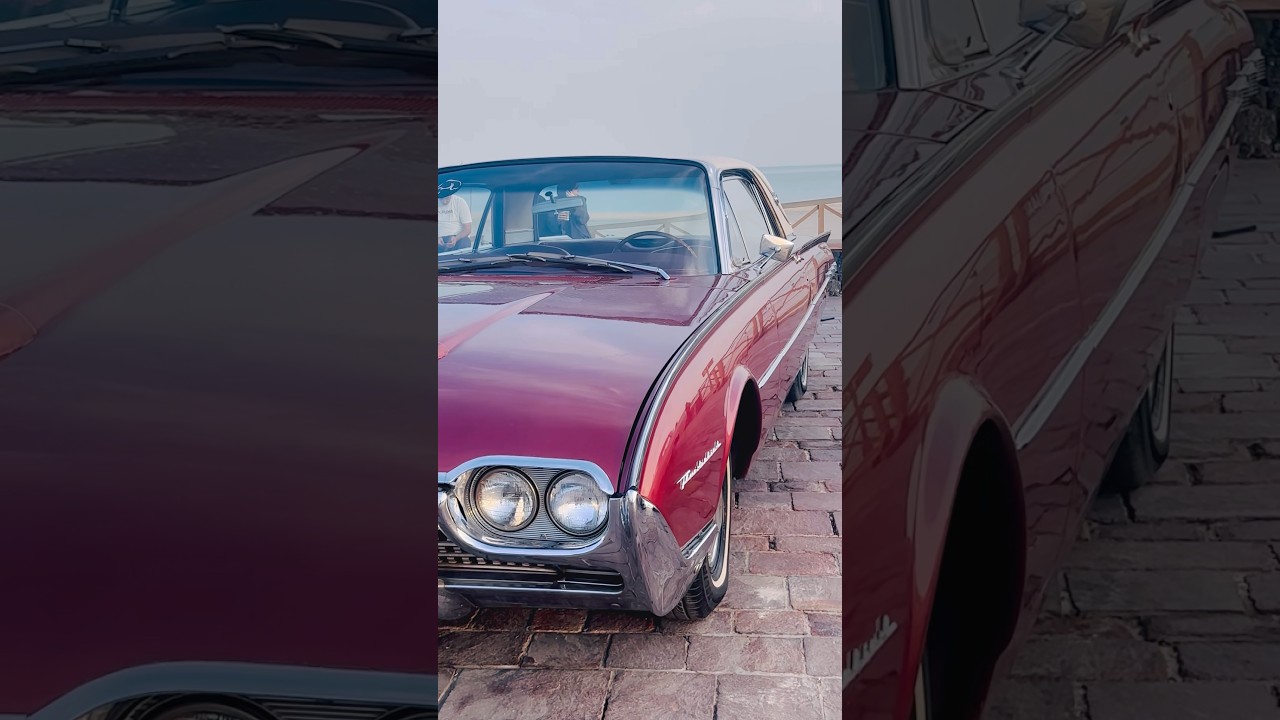 a 1962 model in a maroon or red color. It features jet-age styling with an elongated body