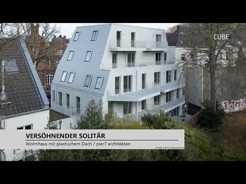 Wohnhaus mit plastischem Dach fügt sich in seine Nachbarschaft ein