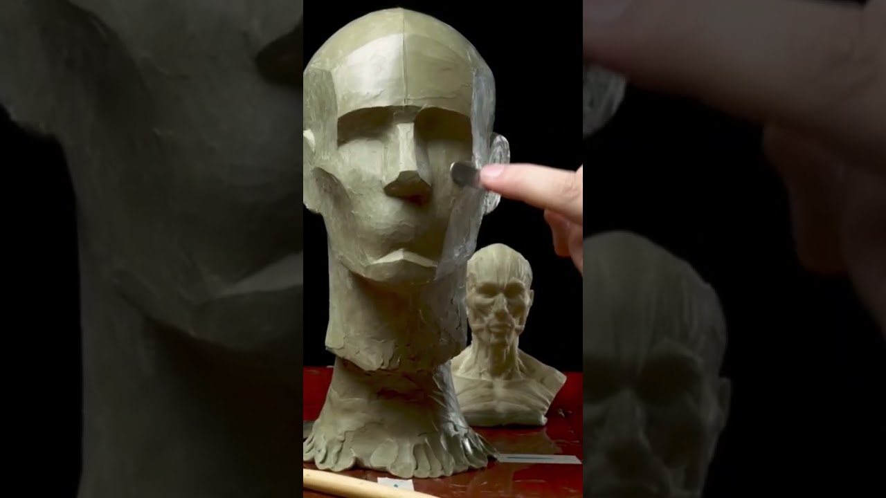 Sculpting simplified male head in clay