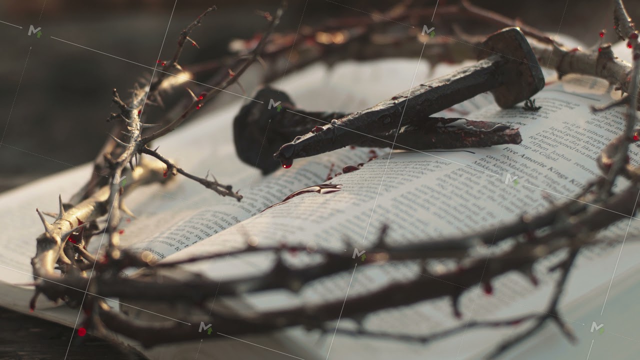 Nails and crown of thorns on Bible