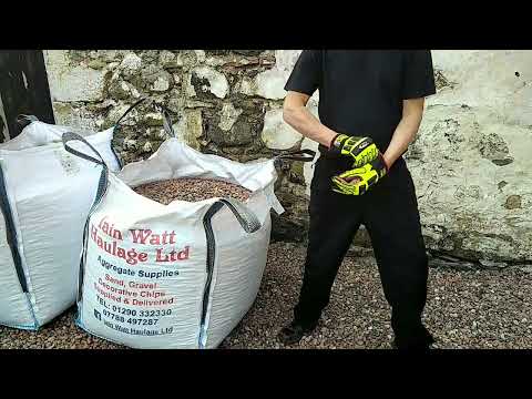 Shovelling stone from a bulk bag. Cut the bag.