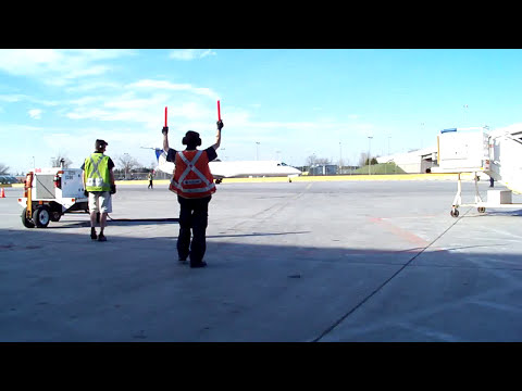 Marshalling Continental Express Embraer 145 into Gate 1 at YOW