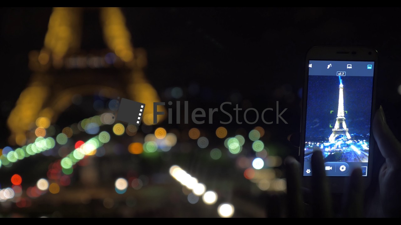 Mobile photo of illuminated Eiffel Tower at night