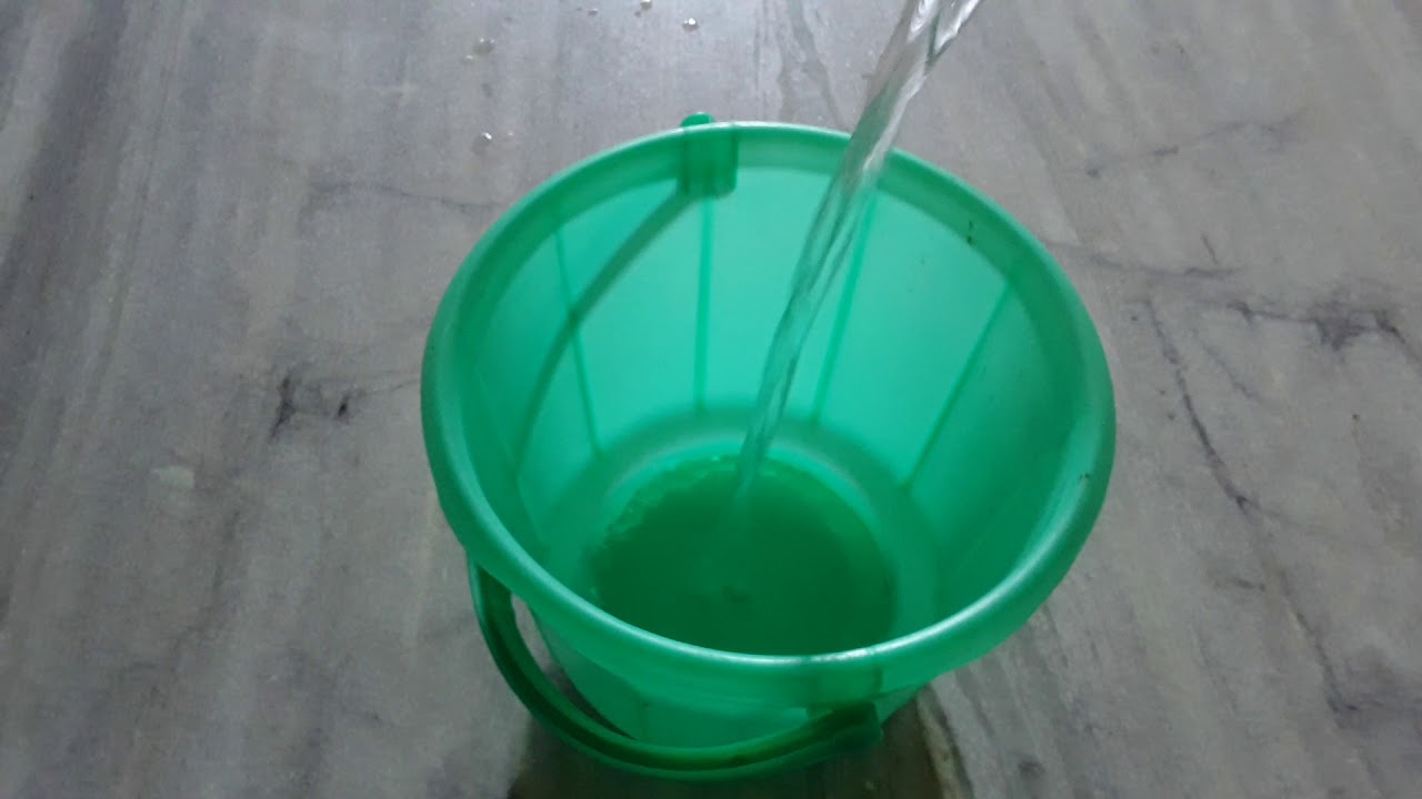 POURING WATER INTO A PLASTIC BUCKET