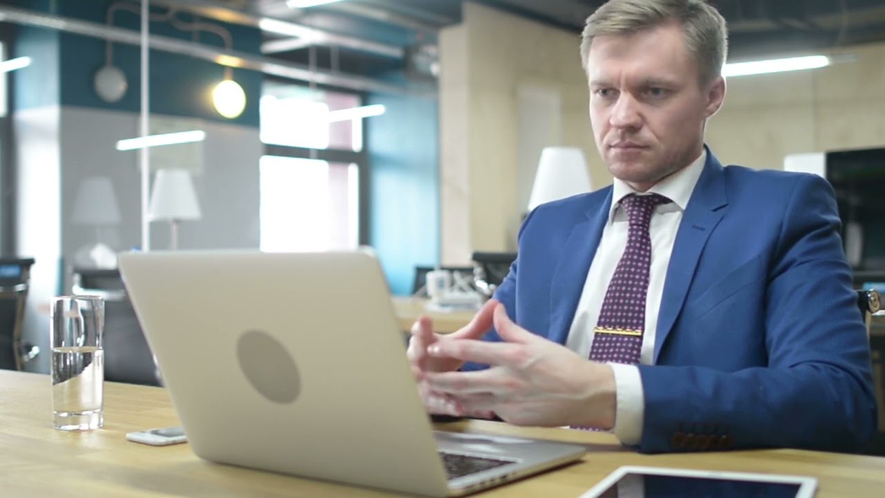 Stock Video Businessman thinking in front of laptop