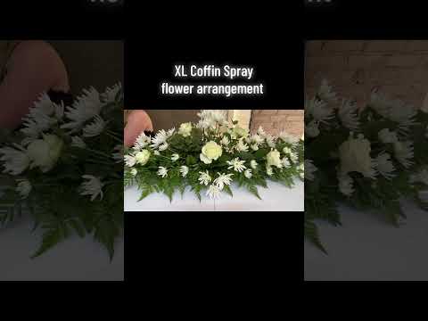 Florist making funeral flowers. Coffin Spray