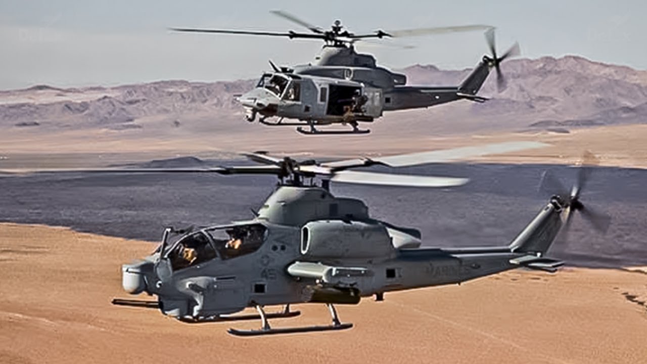 U.S. Marine Corps UH-1Y Venom and AH-1Z Viper Light Attack Helicopters Firing Action in Desert