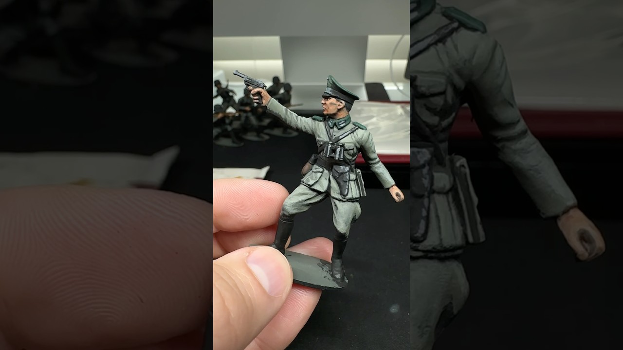 Army men painting German Airfix infantry