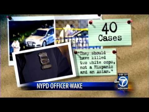Casket of slain NYPD officer arrives at wake, greeted by crowd of officers