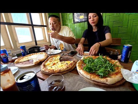 The Italian pizza in Laos. Eating with friends at the restaurant in Sihom. Vientiane, Laos.