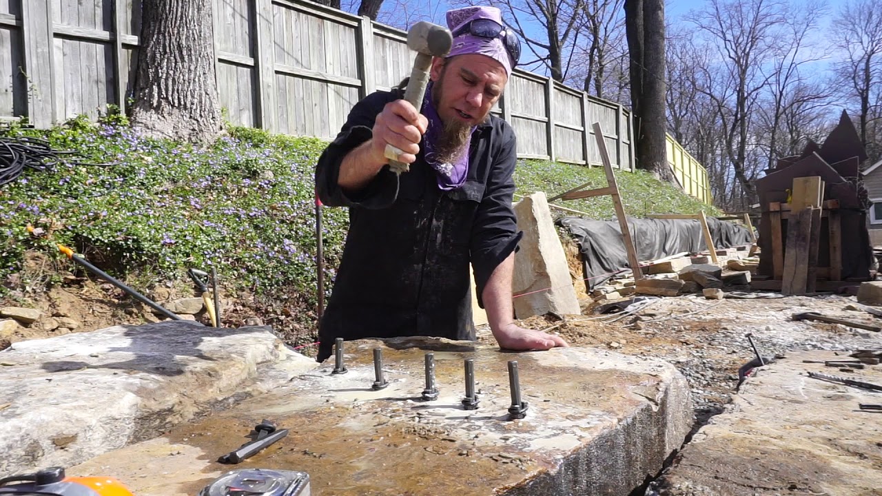 splitting a boulder using the new style feather and plugs | Devin Devine