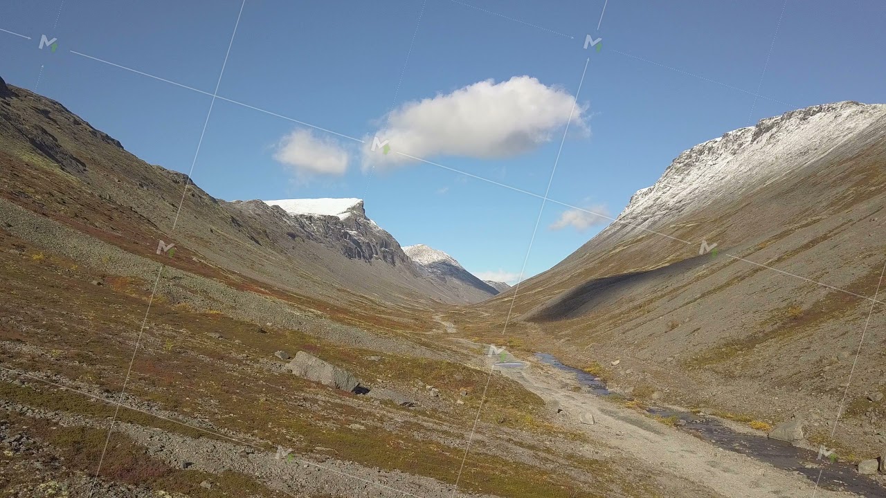 Landscape with mountains covered by snow under cloudy sky in Iceland