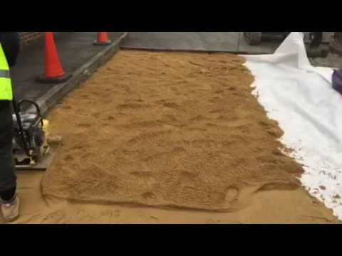 Compacting laying sand for block driveway paving wacker