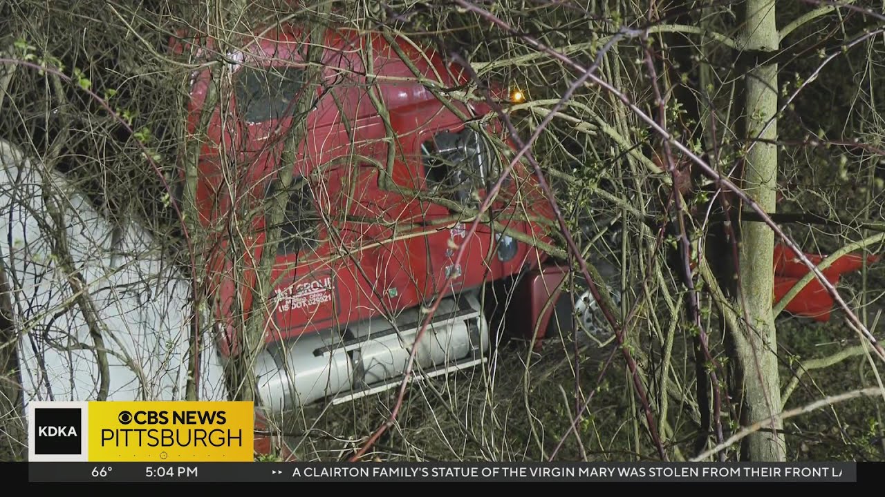 Tractor-trailer overturns, spilling chemicals into stream