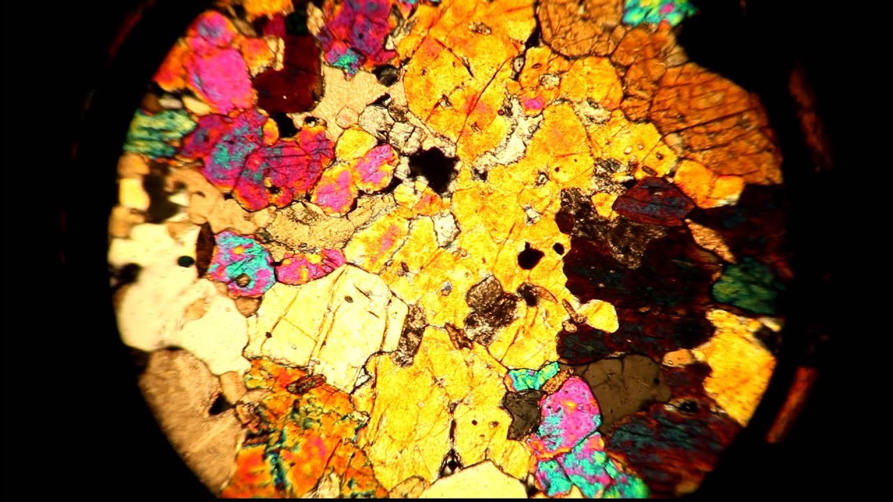 A thin section viewed through a petrographic microscope with stage rotation
