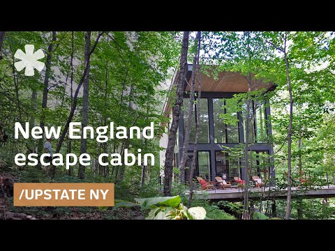Modern cabin hangs like a treehouse over Acadian New England