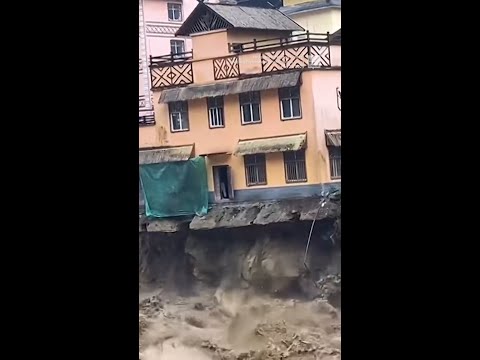 China Flood Sends Building Into River