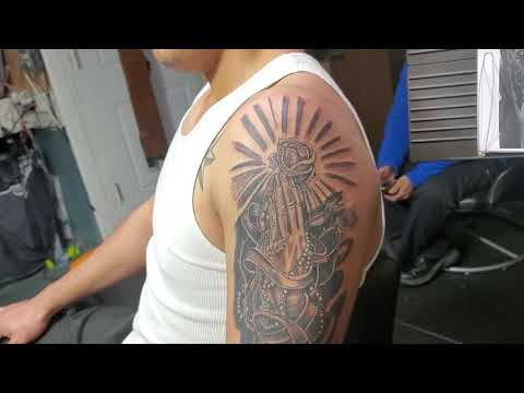 Praying hands with rosary and scroll tattoo by Boris Kuryakin, December 18, 2019.