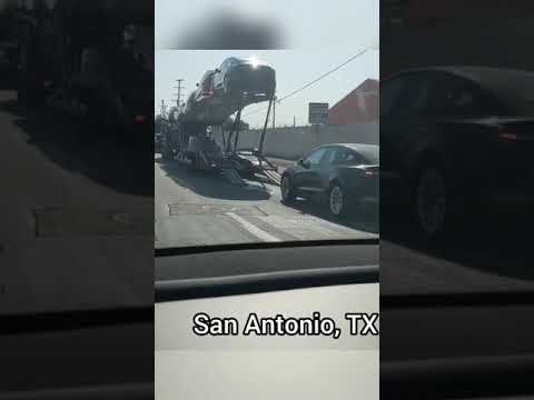 Two vehicle carriers delivering Tesla Model 3s to the Hertz location near the San Antonio airport.