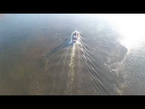 Aerial footage of a Cargo ship passing through the Tacony Palmyra Bridge