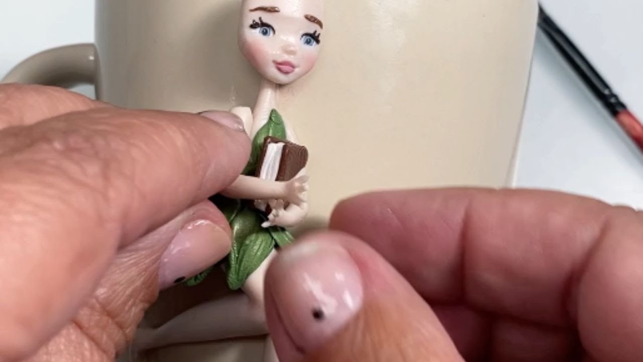 The artist's polymer clay 'Tinkerbell' decoration turns a plain mug into a unique masterpiece