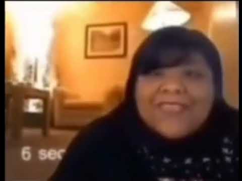 Girl speaking Spanish and saying merry Christmas while Christmas tree burns in background