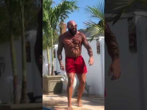 muscle guy dancing to Spanish music by pool