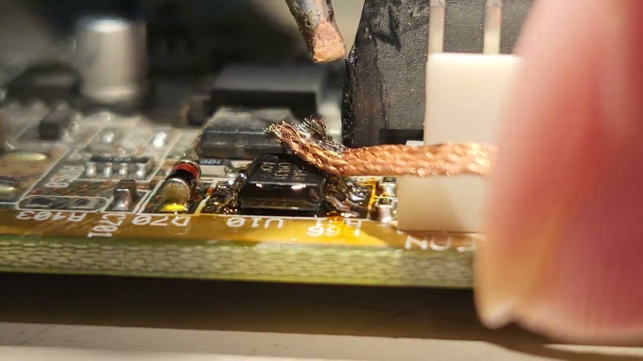 Removing a small outline integrated circuit (SOIC) from a motherboard.